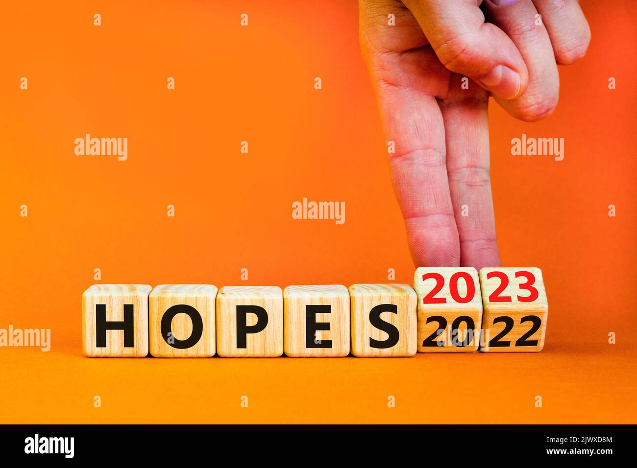 2023 hopes new year symbol. Businessman turns a wooden cube and changes ...