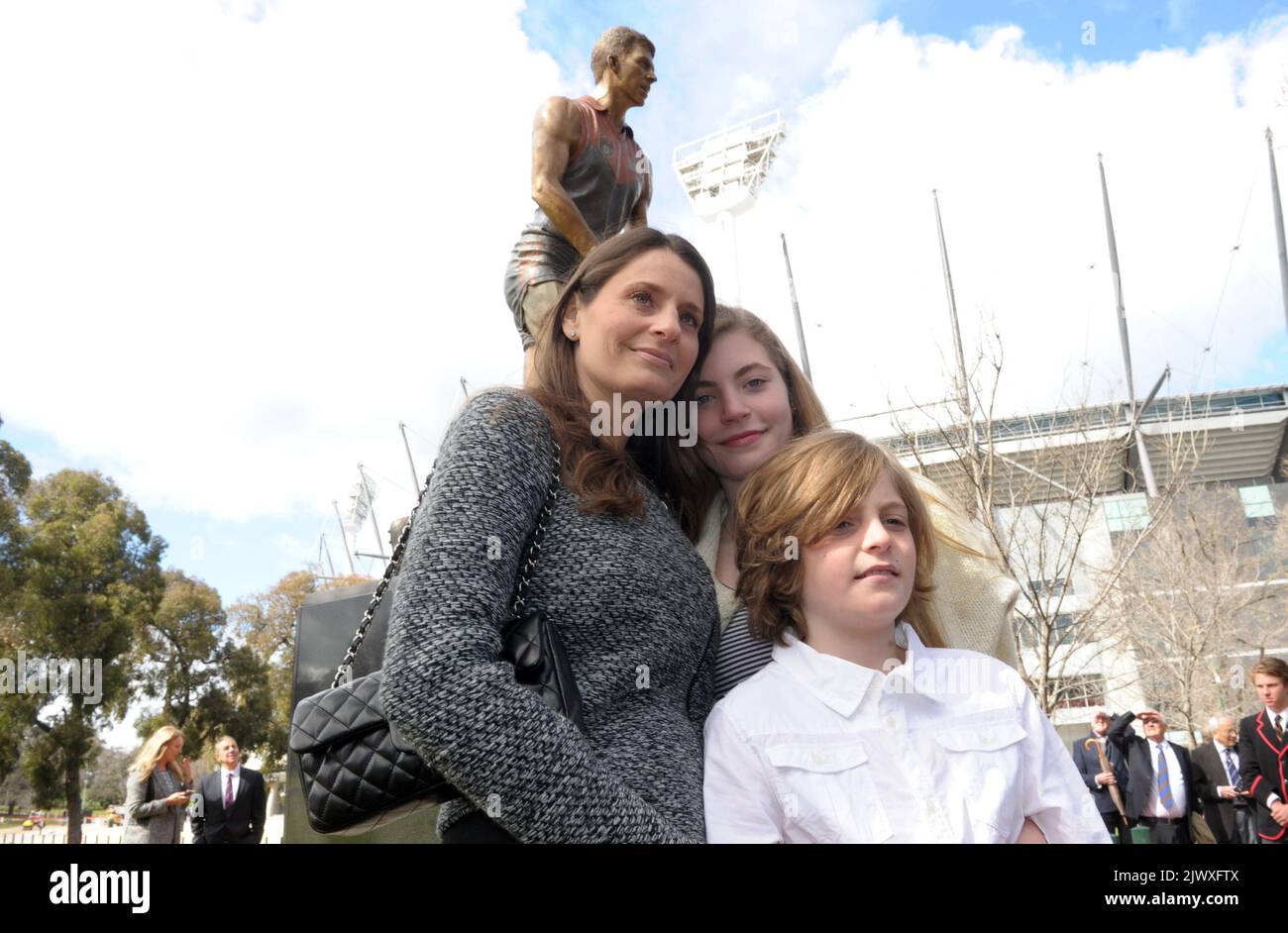 Sam, Matisse and Tiernan Stynes pose for photos in front of the statue ...
