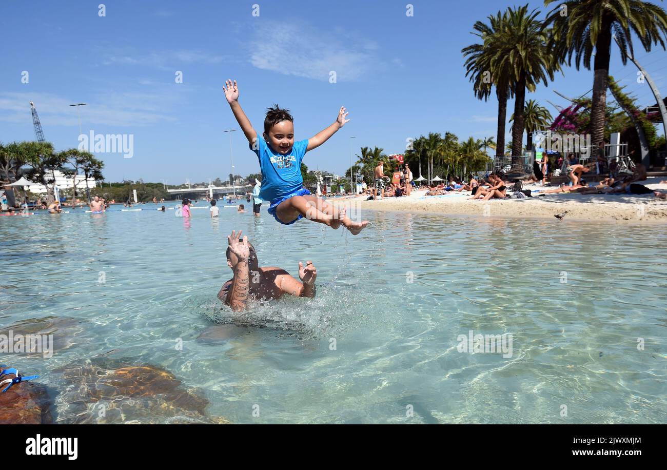 Three year-old Jaxsyn Wilson and his dad Reece escape the hot weather ...