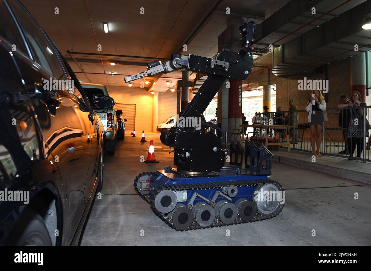 A bomb disposal robot approaches a car during a vehicle search ...