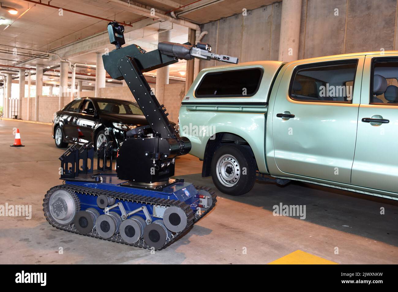A bomb disposal robot approaches a car during a vehicle search ...