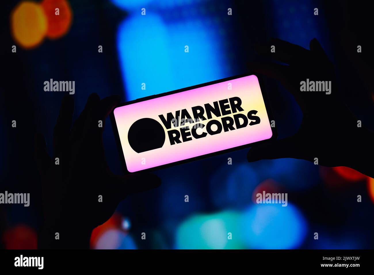 In this photo illustration, the Warner Records logo is displayed on a ...