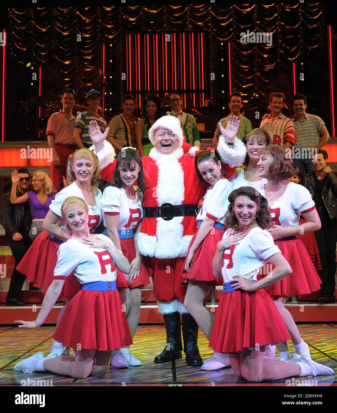 Bert Newton (centre) dressed as Santa Claus poses for a photo with cast ...