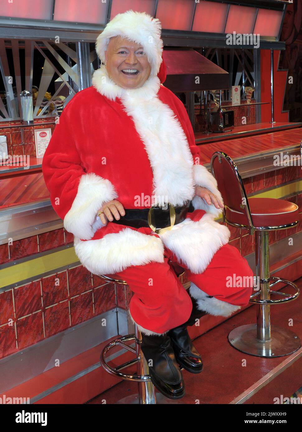 Bert Newton poses for a photo dressed as Santa Claus on the set of ...
