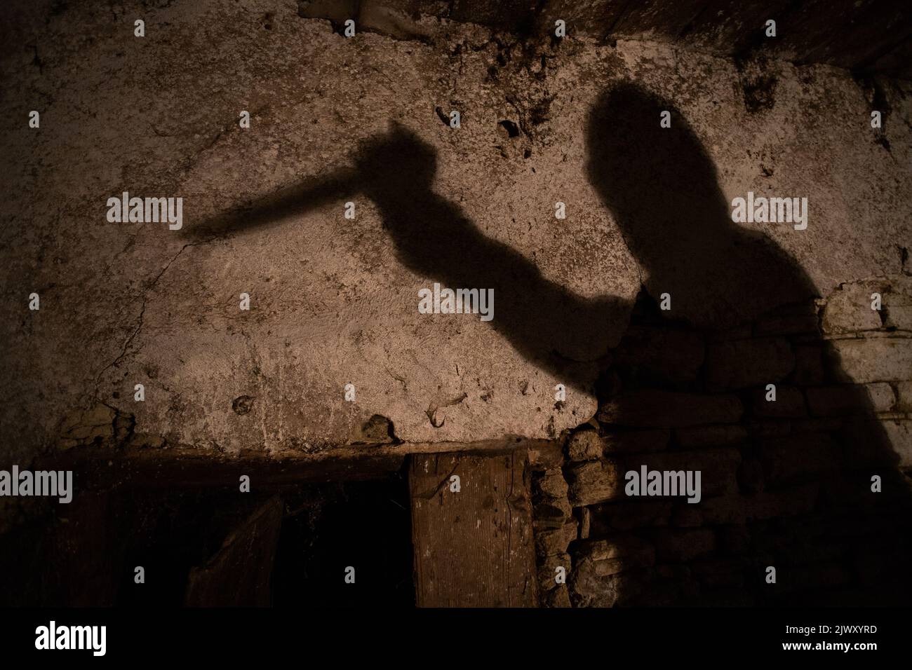 murderer with big knife and shadow horror scene Stock Photo - Alamy