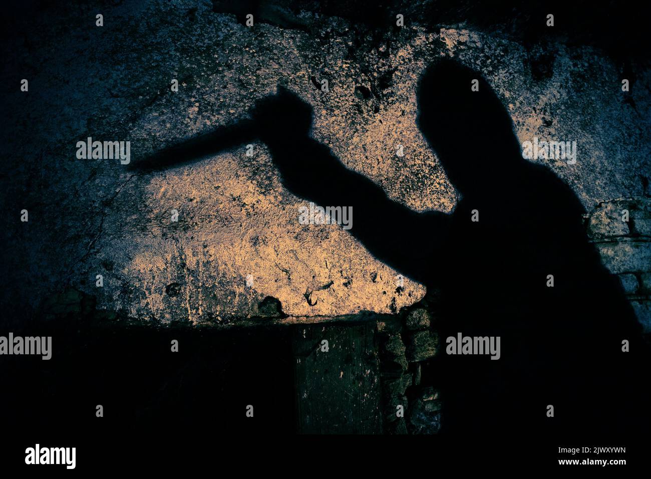 murderer with big knife and shadow horror scene Stock Photo - Alamy