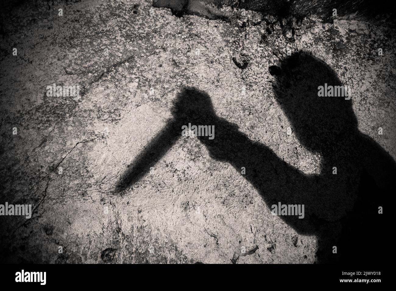murderer with big knife and shadow horror scene Stock Photo - Alamy