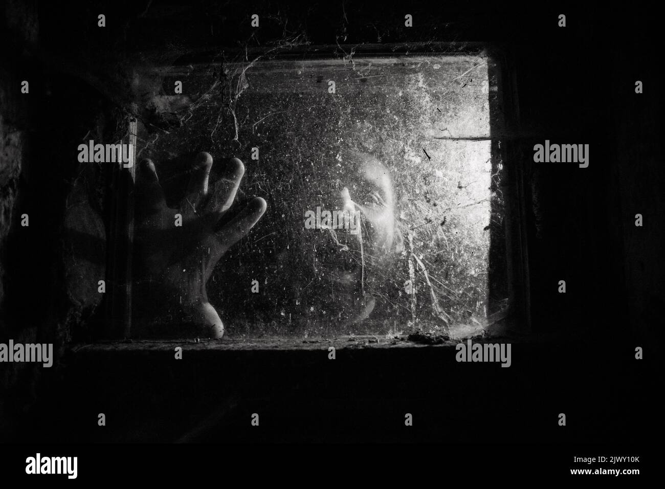 scary man behind window with spider nets at night Halloween horror ...