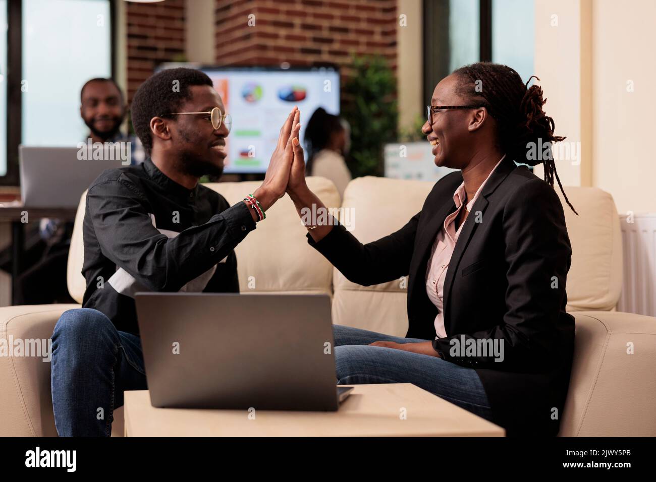 Team of coworkers giving highfive at job, doing work collaboration on ...