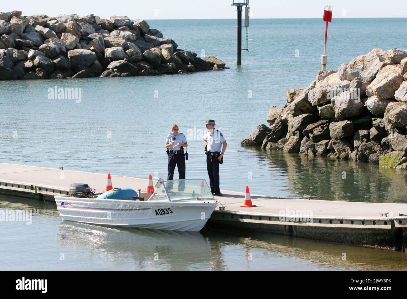 Police officers inspect the boat which was towing the shark attack ...