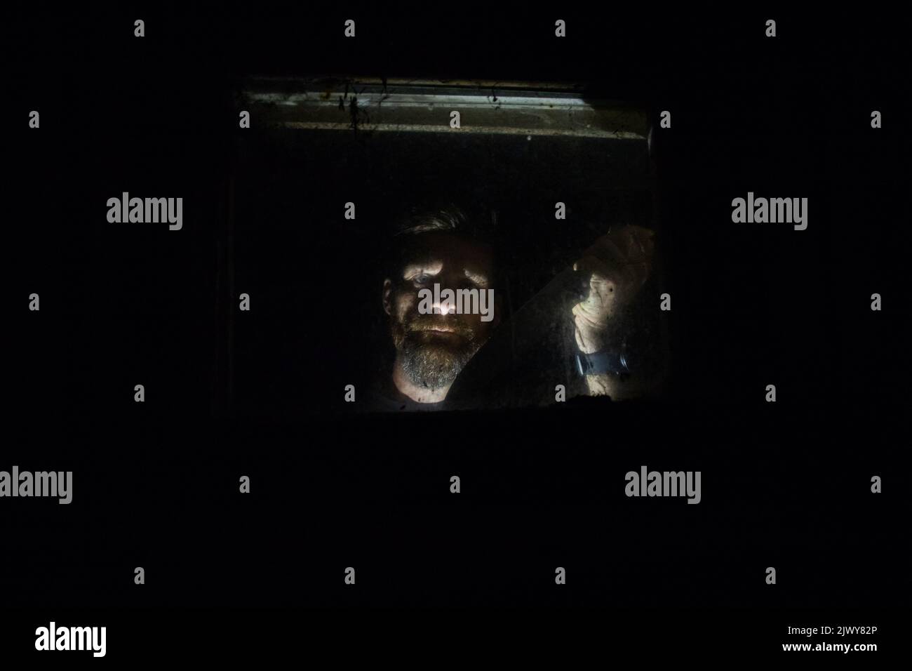 scary man behind window with spider nets at night Halloween horror ...