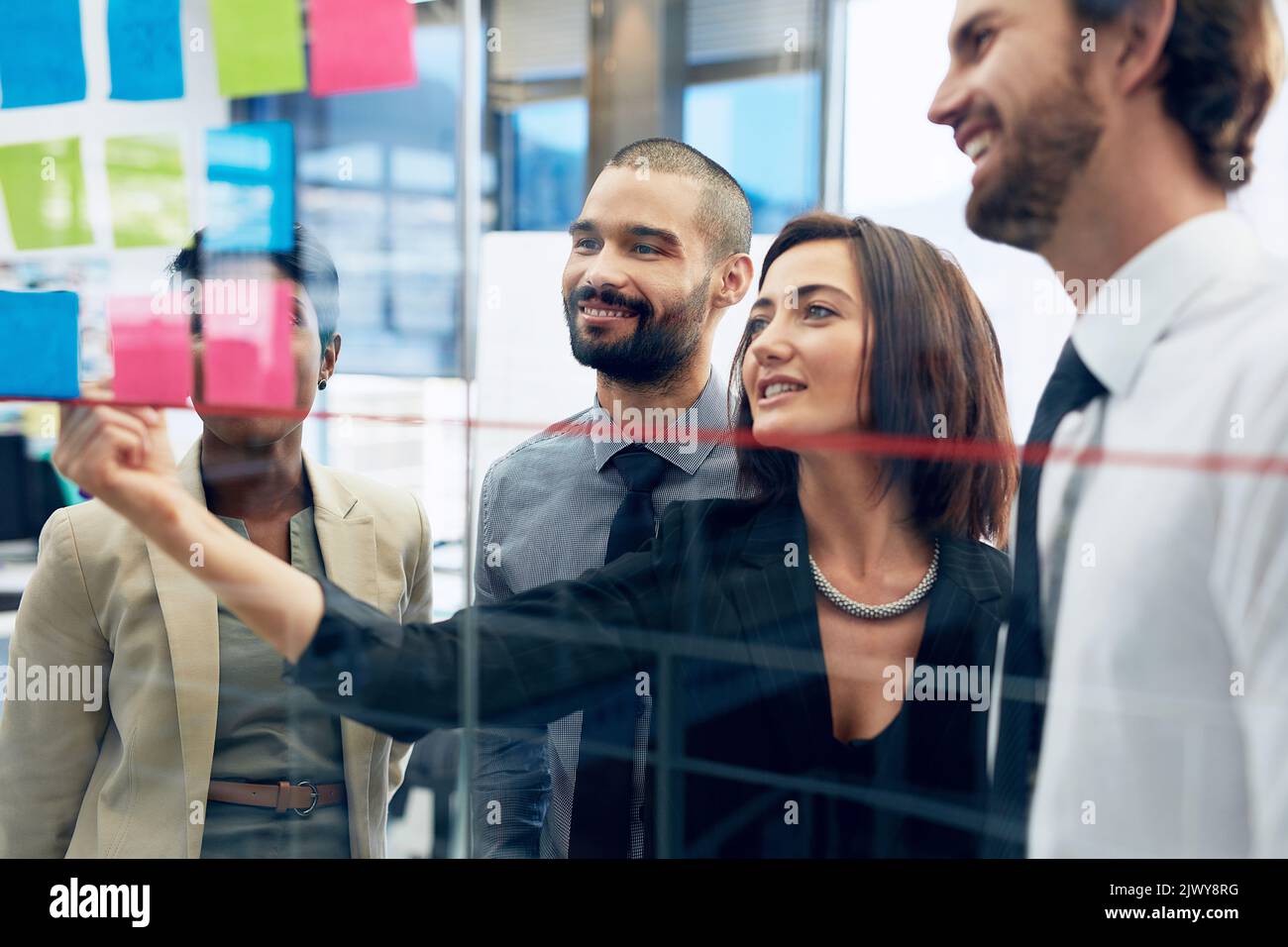 Theyre happy to put their heads together. colleagues brainstorming in ...