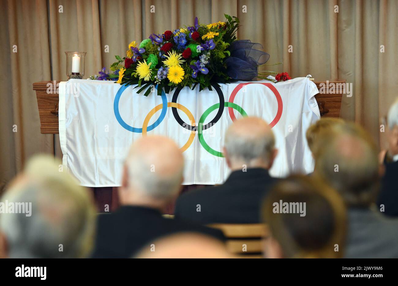 The Olympic flag is draped over the coffin during the funeral for ...
