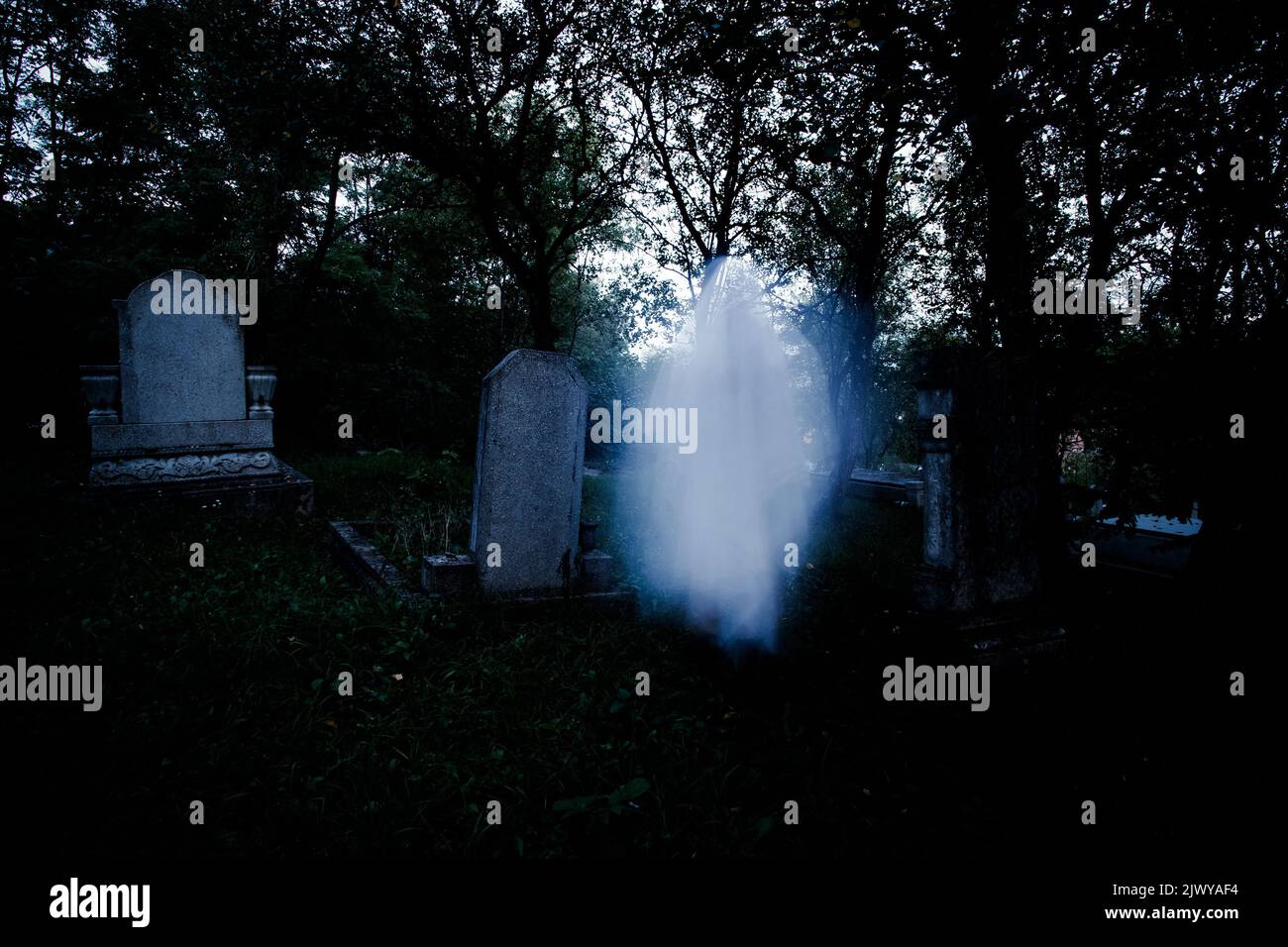 scary ghost in cemetery at night Halloween background Stock Photo - Alamy