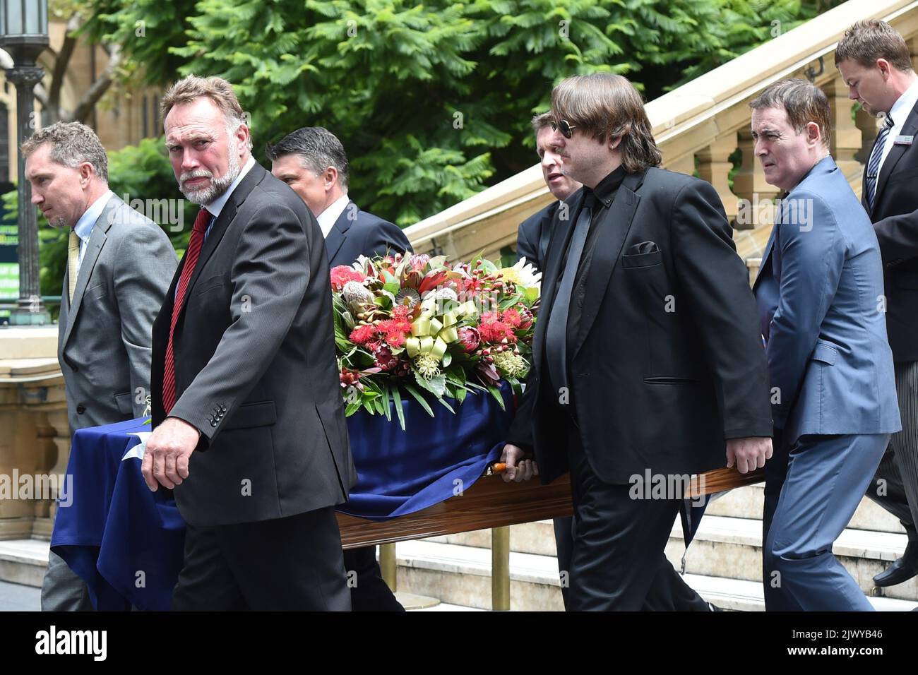 Michael Uren (2nd from left) carries his father's casket from Sydney ...