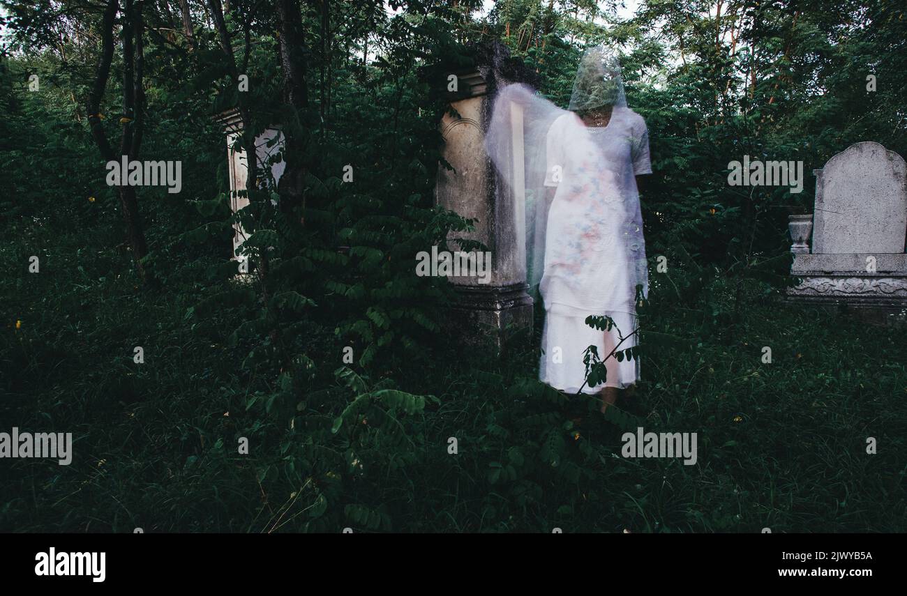 scary ghost in cemetery at night Halloween background Stock Photo - Alamy