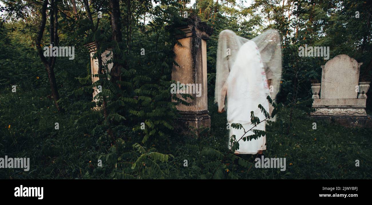 scary ghost in cemetery at night Halloween background Stock Photo - Alamy