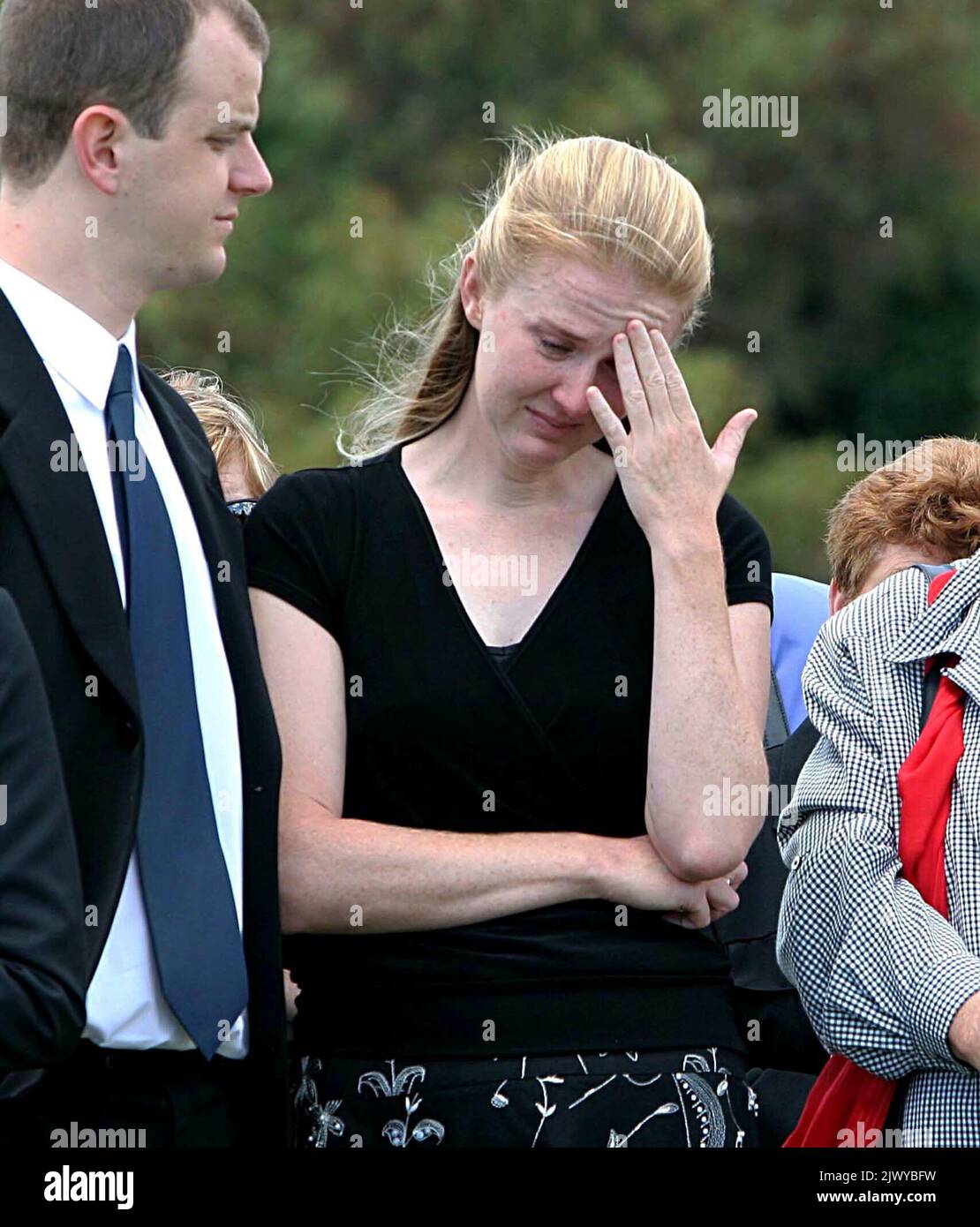 Sarah Roberts sobs while comforted by a close friend on Adelaide High ...