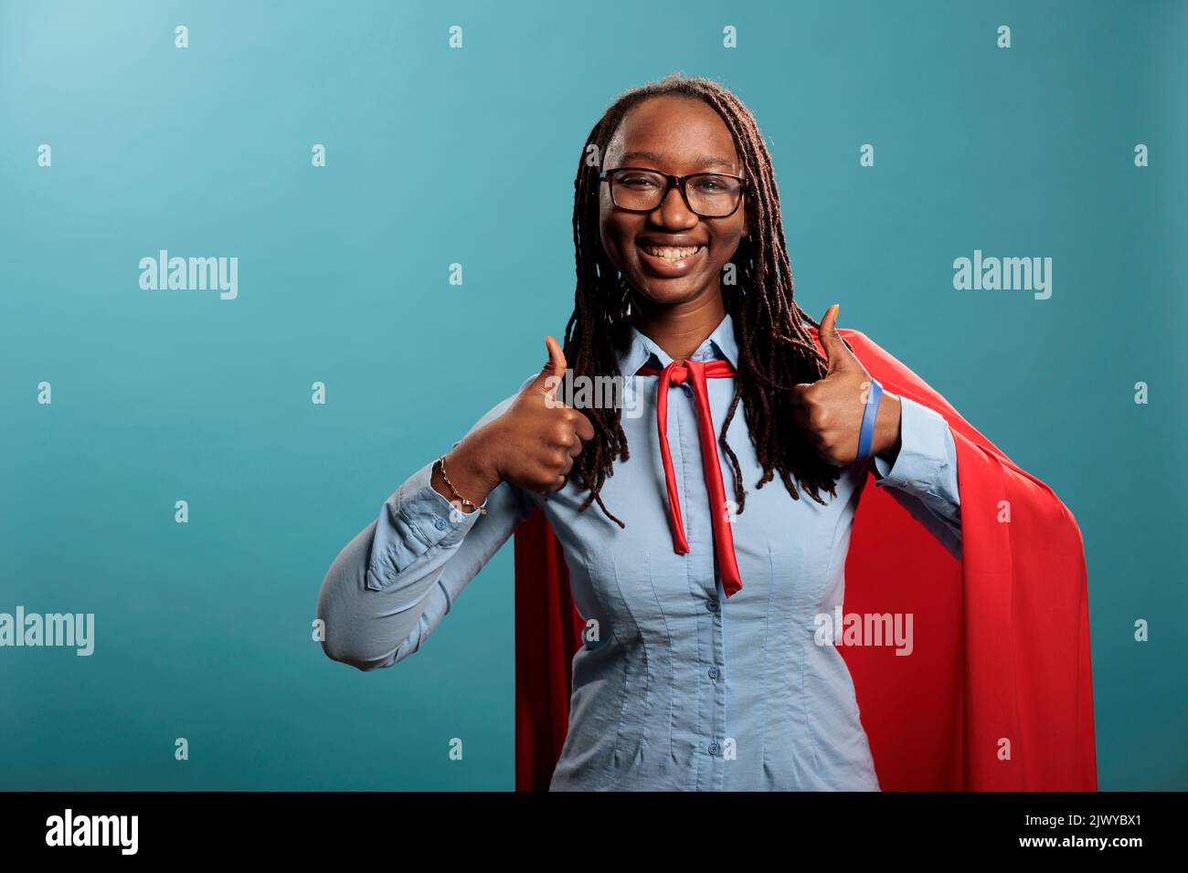 Positive smiling heartily justice defender wearing mighty hero red cape ...