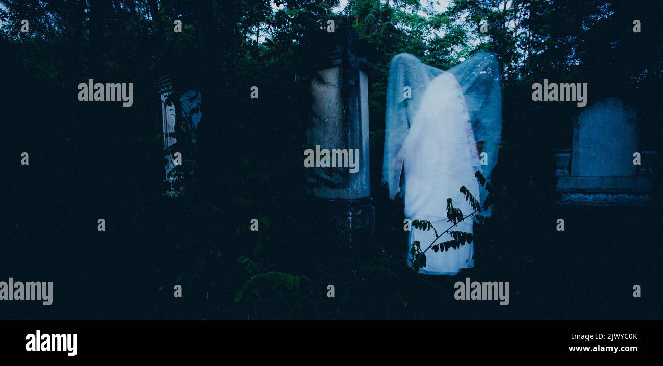 scary ghost in cemetery at night Halloween background Stock Photo - Alamy