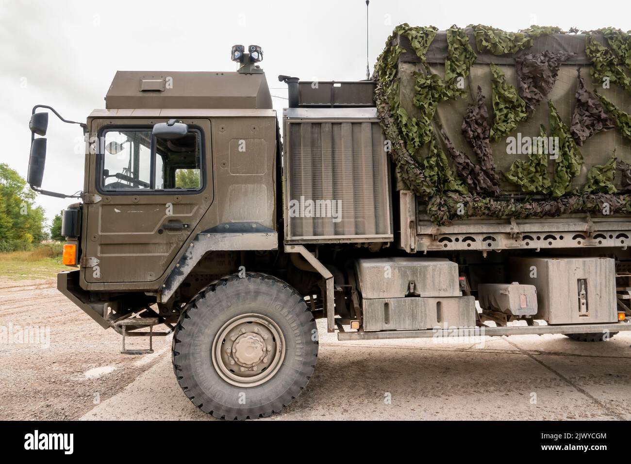 British army MAN SV HX60 4x4 logistics truck crossing open countryside ...