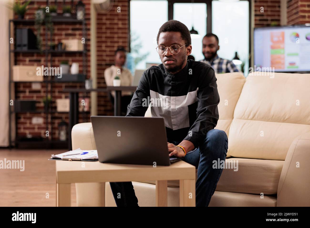 African american man working on laptop pc to plan business presentation ...