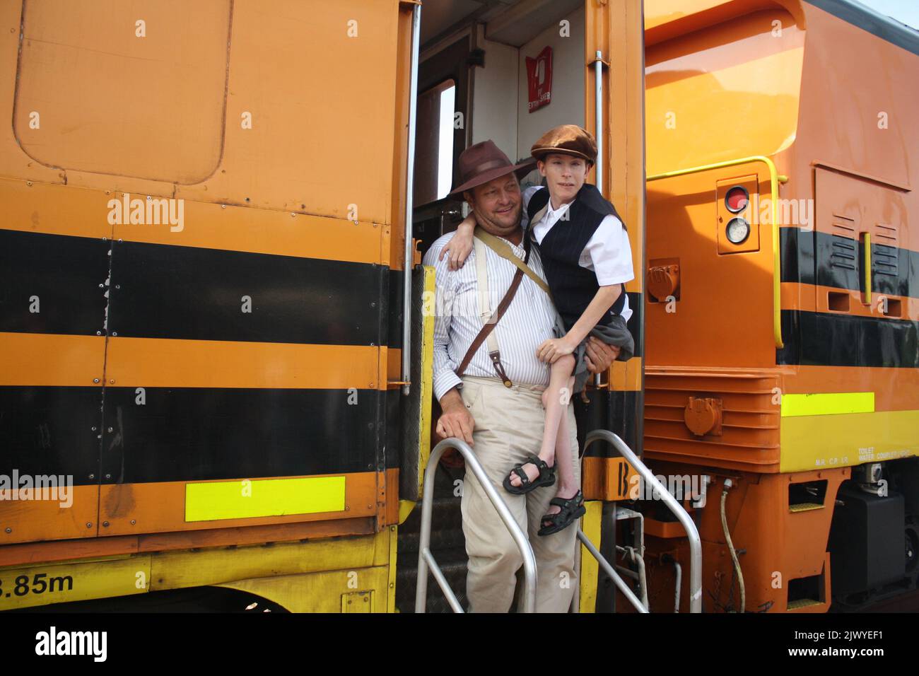 Richard Borella carries his son Joshua off the train in Darwin on the ...