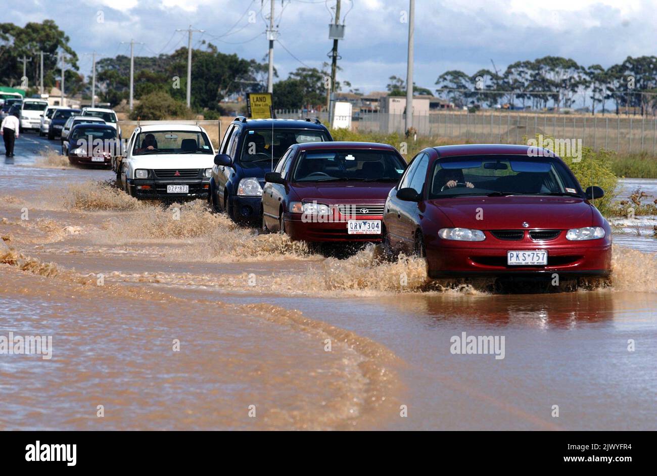 Drivers try to cross one of the few roads that are crossable in the ...
