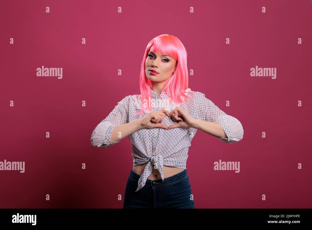 Happy smiling person doing heart shaped symbol with hands, advertising ...