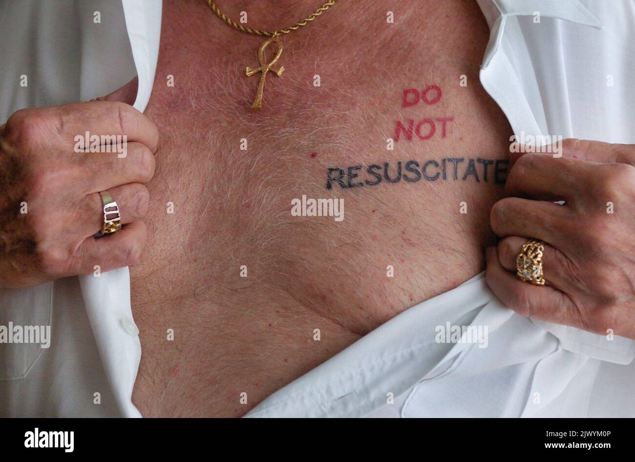 Retired Doctor Albert Cutter displaying off his new tattoo which reads ...