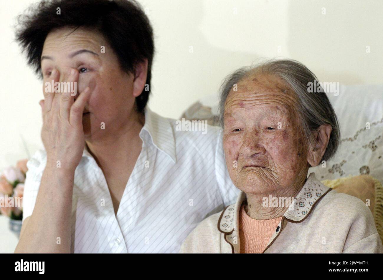 One hundred and four year-old Chinese immigrant Cui Yu Hu sits at home ...