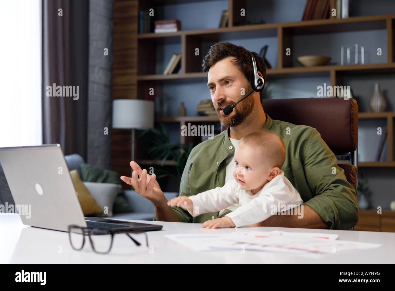 Father on maternity leave, holding an online conference, a meeting in ...