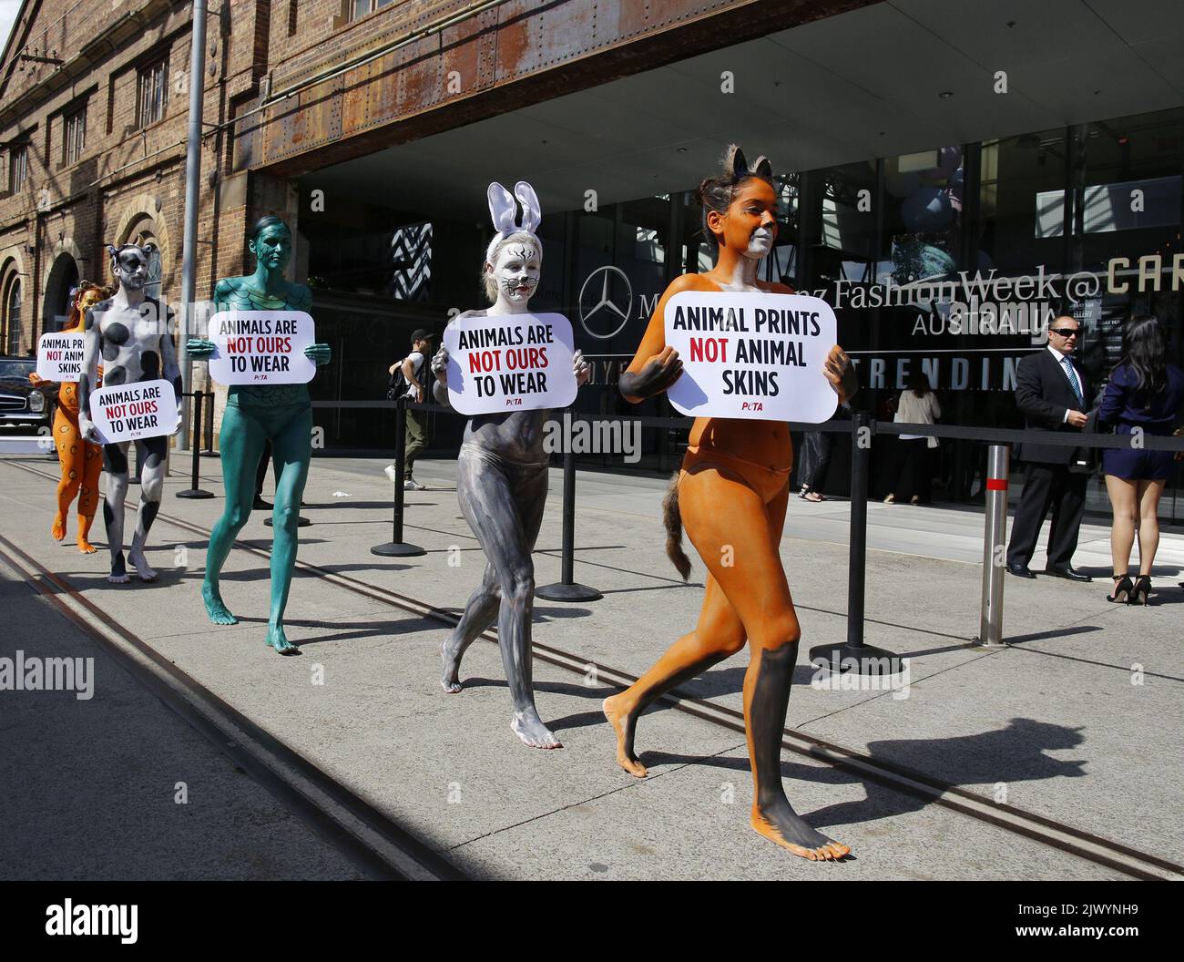 Members of PETA with their bodies painted like animals protest outside ...