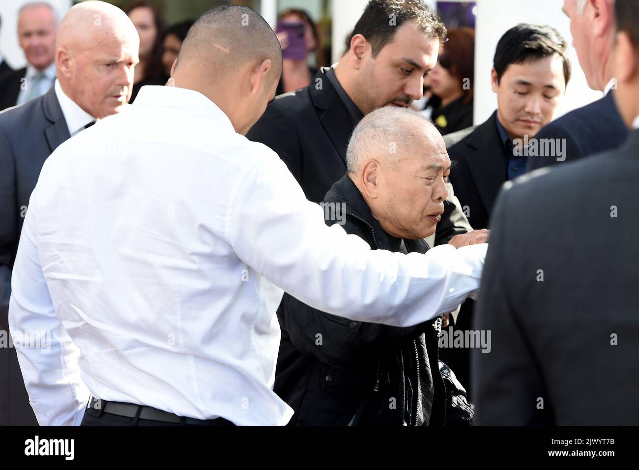 Ken Chan, (centre), the father of Andrew Chan, pays his respects at the ...