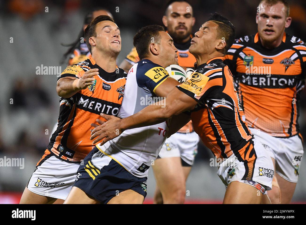 Antonio Winterstein of the Cowboys is tackled by Tim Simona of the ...