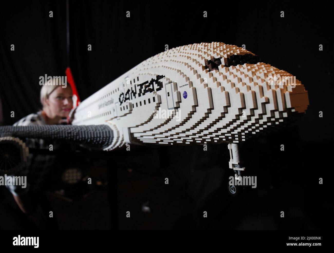 Lego enthusiast Angela Ceberano looks on at a Qantas A380 jet, one of ...