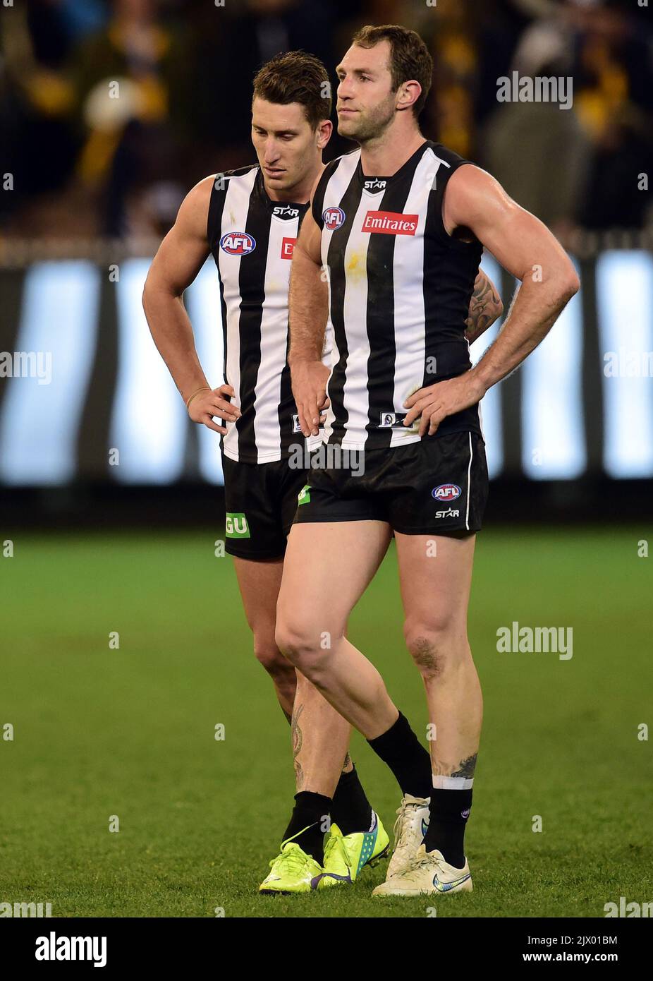 Collingwood Magpies player Jesse White (left) and Travis Cloke react ...