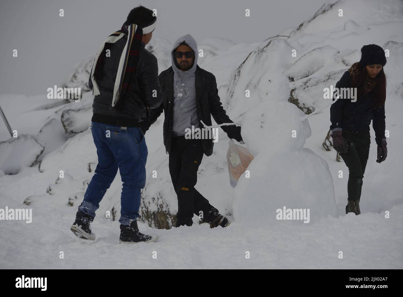Tourists build a snowman at Falls Creek ski field, north of Melbourne ...