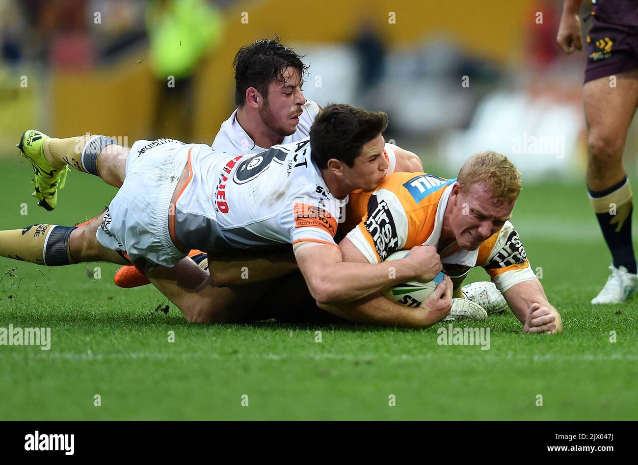 Jack Reed of the Brisbane Broncos (right) is tackled by Mitchell Moses ...