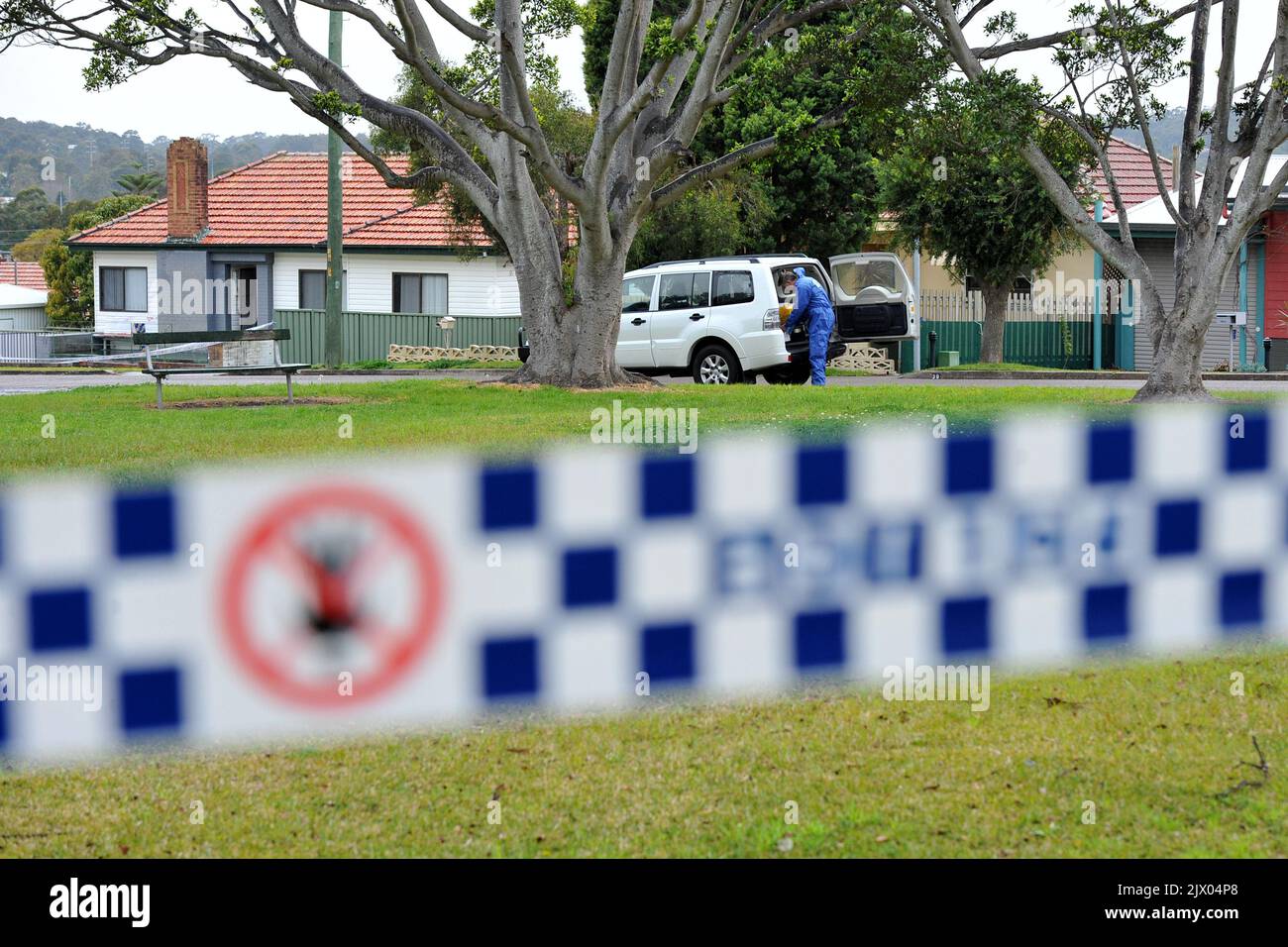 A New South Wales forensic officer is seen near a home where a six week ...