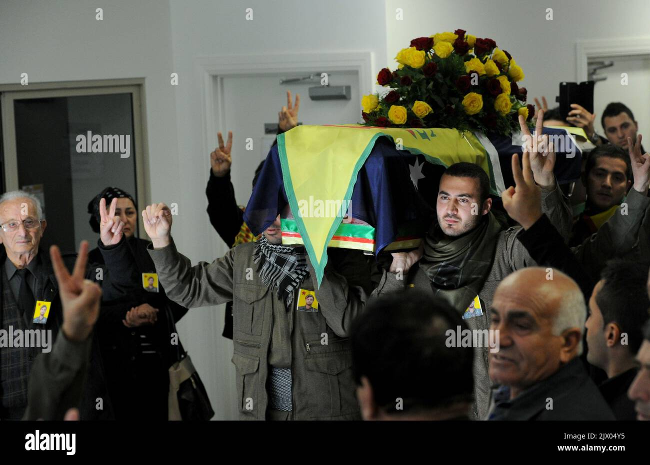 The coffin of Reece Harding is carried into his Kurdish funeral service ...