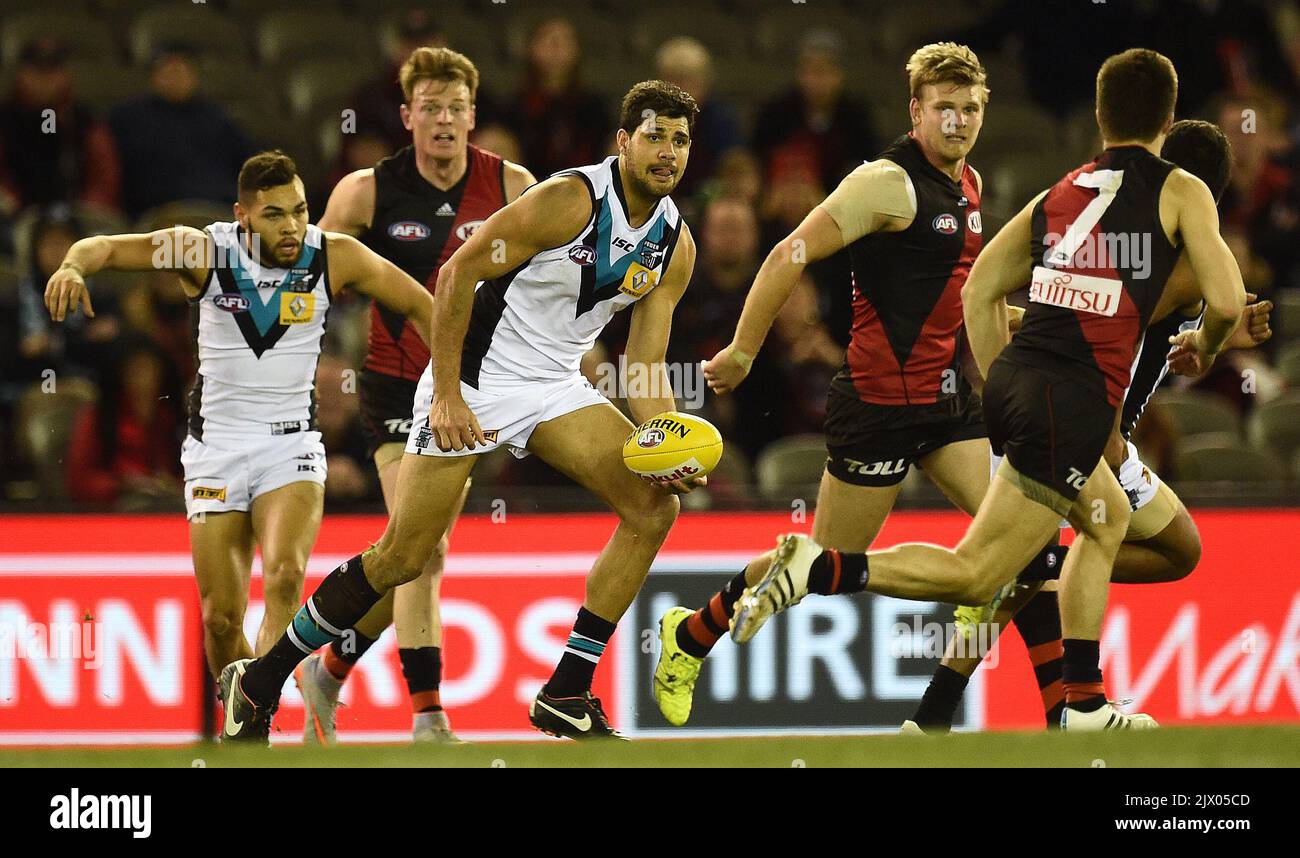 Port Adelaide Power player Patrick Ryder (centre) handballs against the ...