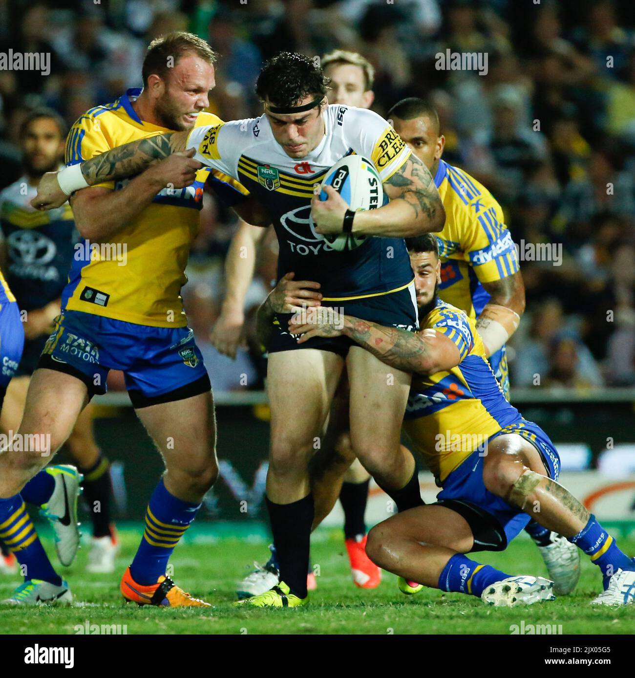 Cowboys Ethan Lowe is wrapped up by Eels defence including David Gower ...
