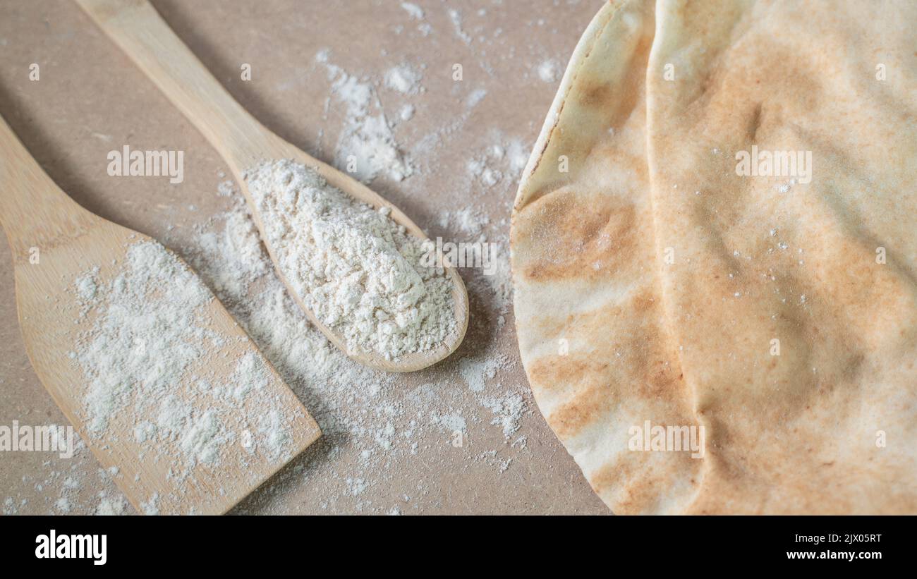 Arabic bread on a brown table in the bakery kitchen Stock Photo - Alamy