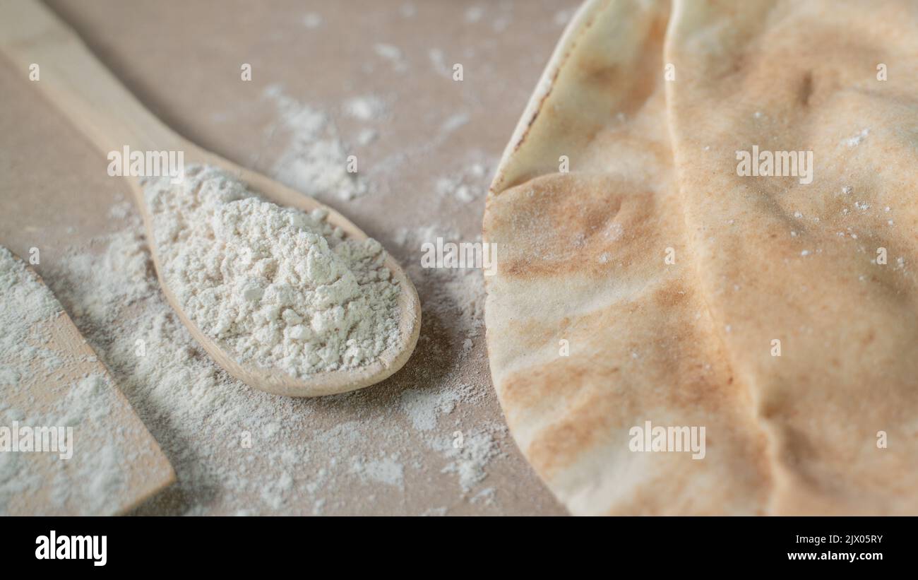 Arabic bread on a brown table in the bakery kitchen Stock Photo - Alamy
