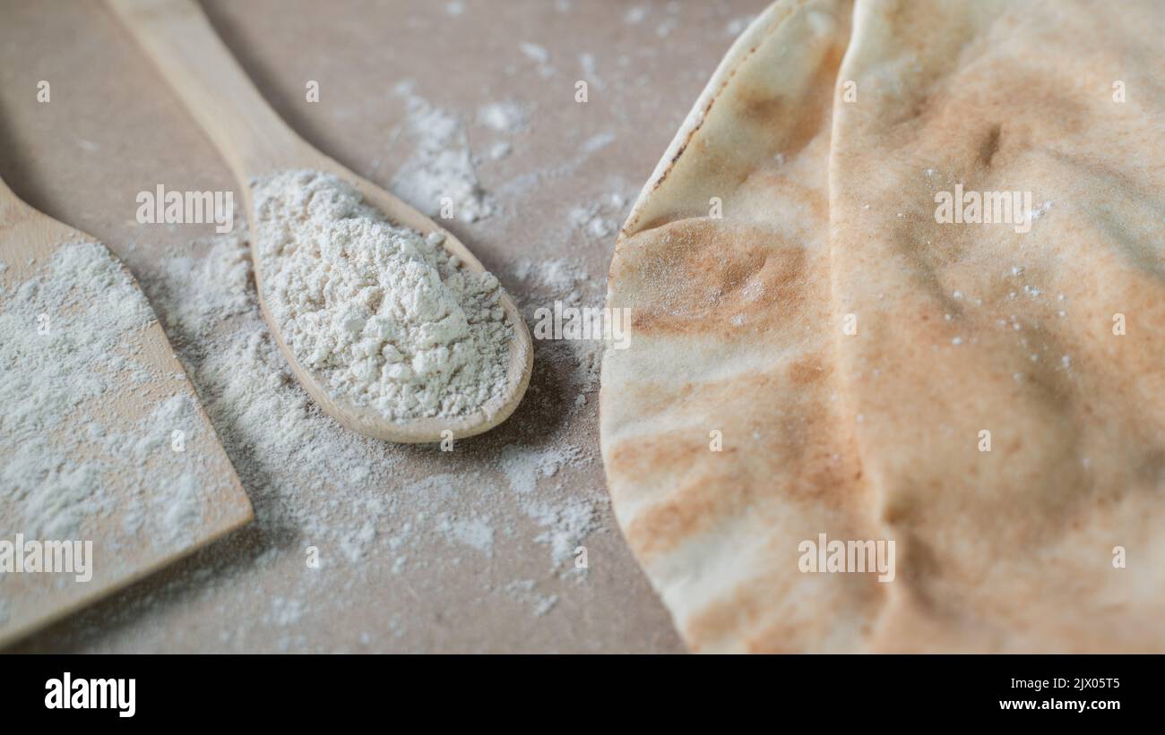 Arabic bread on a brown table in the bakery kitchen Stock Photo - Alamy