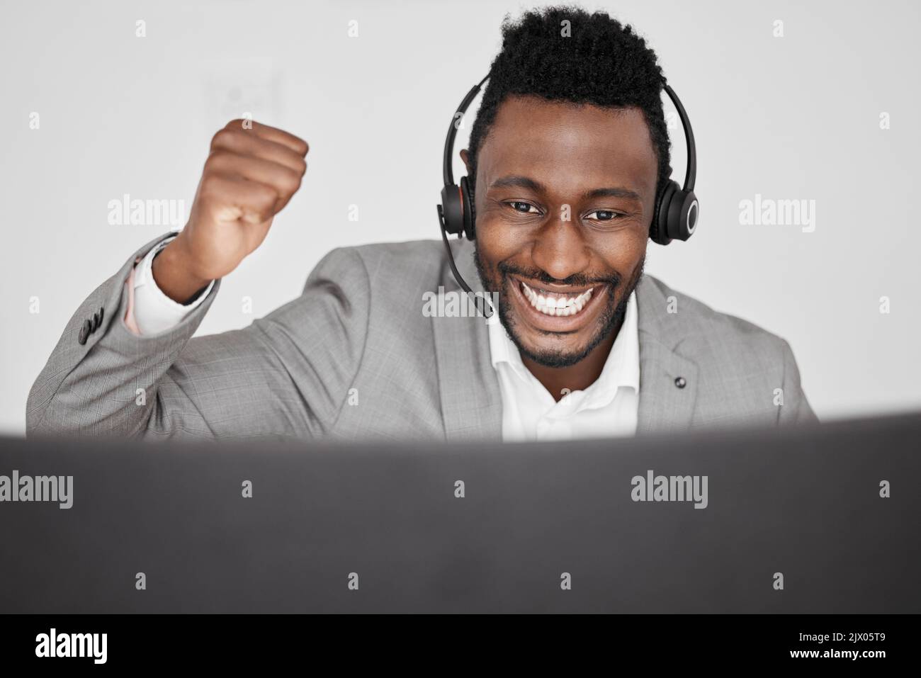 Call center, customer service or telemarketing worker with celebration ...