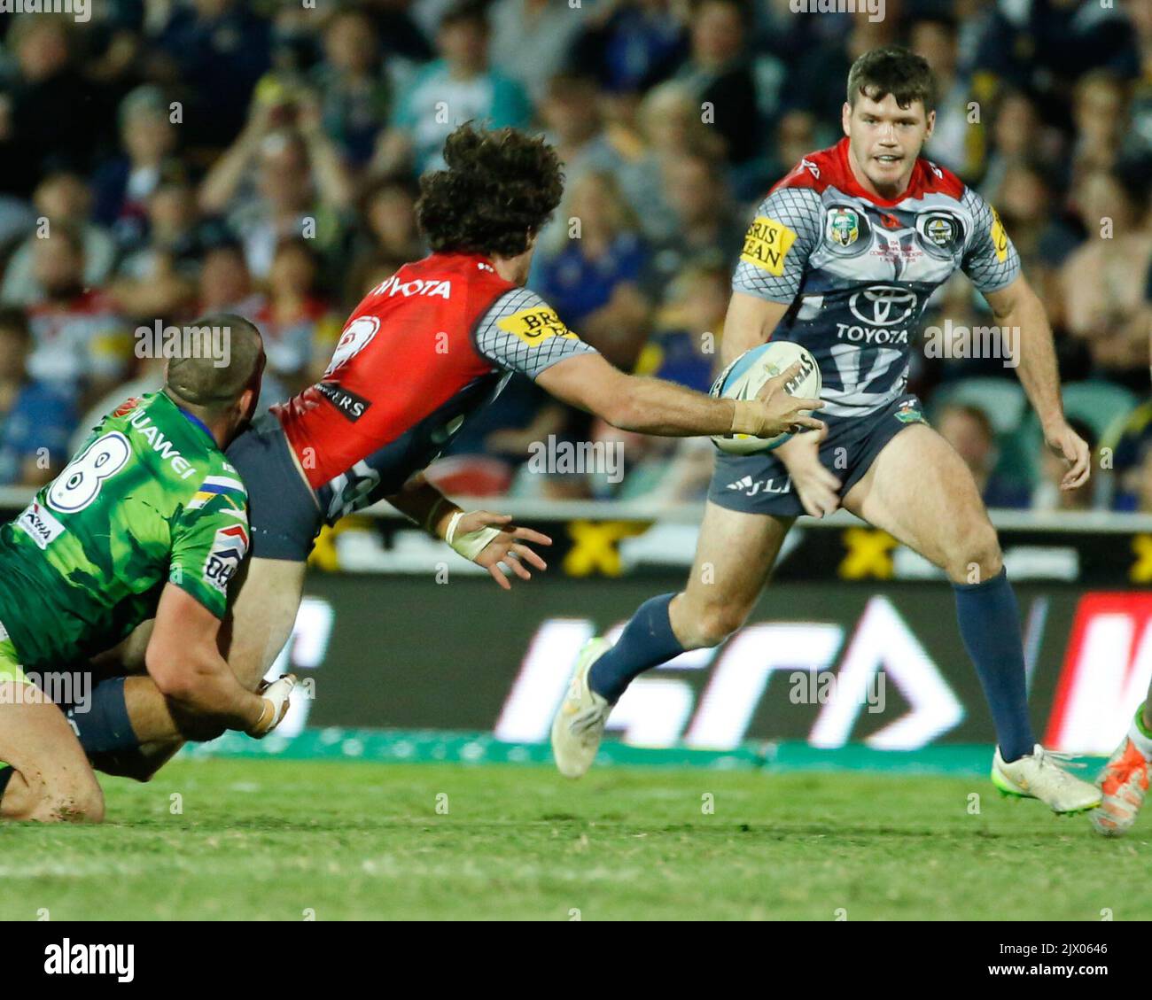 North Queensland Cowboys' Jake Granville (centre) gets a pass away to ...
