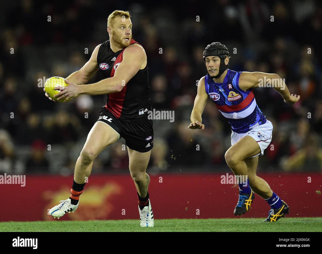 Essendon Bombers player Adam Cooney (left) and Western Bulldogs player ...