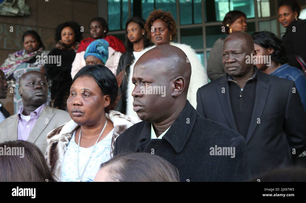 Joseph Tito Manyang (centre), the father of the three children killed ...